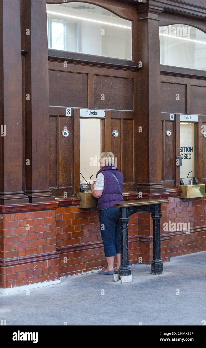 Rail passenger buying rail tickets at Manchester Victoria railway ...