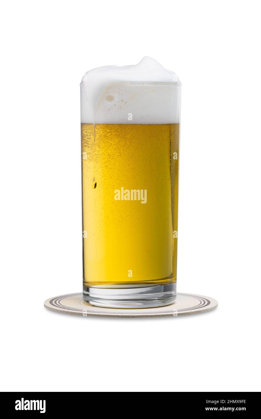overflowing beer in a glass with on a beermat Stock Photo - Alamy