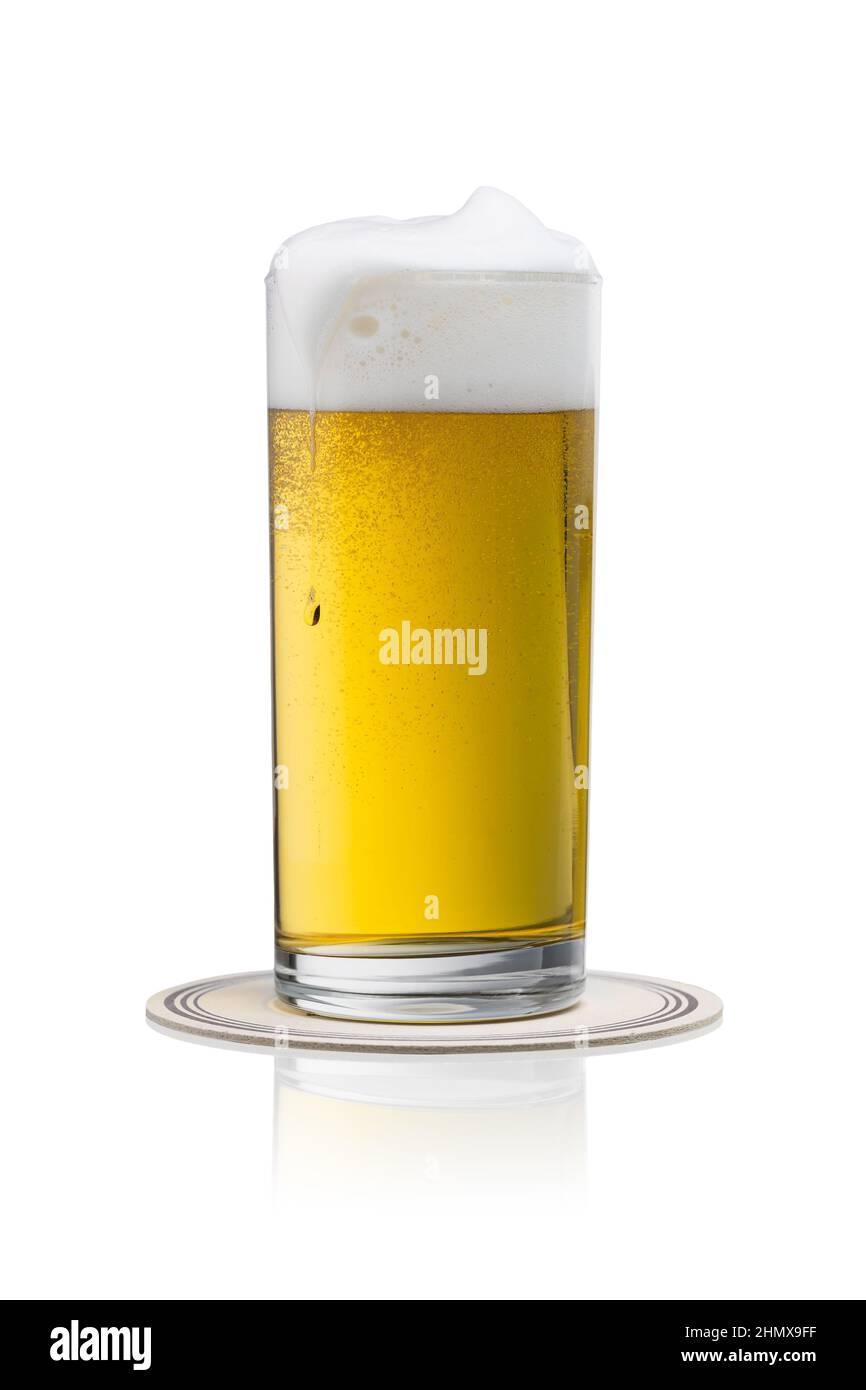 overflowing beer in a glass with drop Stock Photo - Alamy