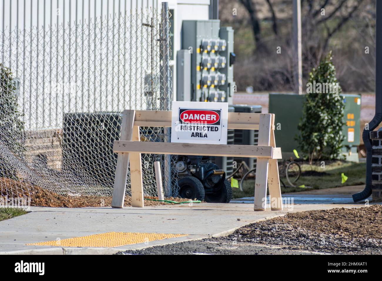 Horizontal shot of a construction barricade in front of a new apartment ...