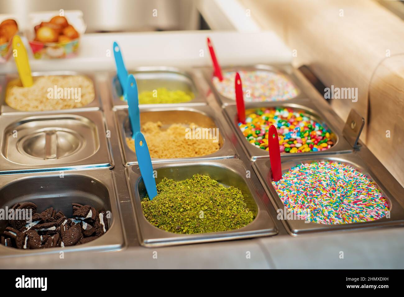 Fresh Fried Donuts sugary sprinkles toppings for donuts in a cafe on ...