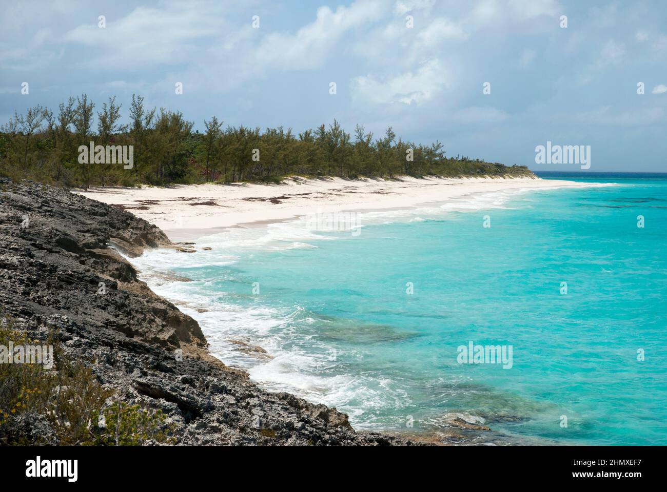 The scenic view of rocky coastline and sandy beach on Half Moon Cay ...