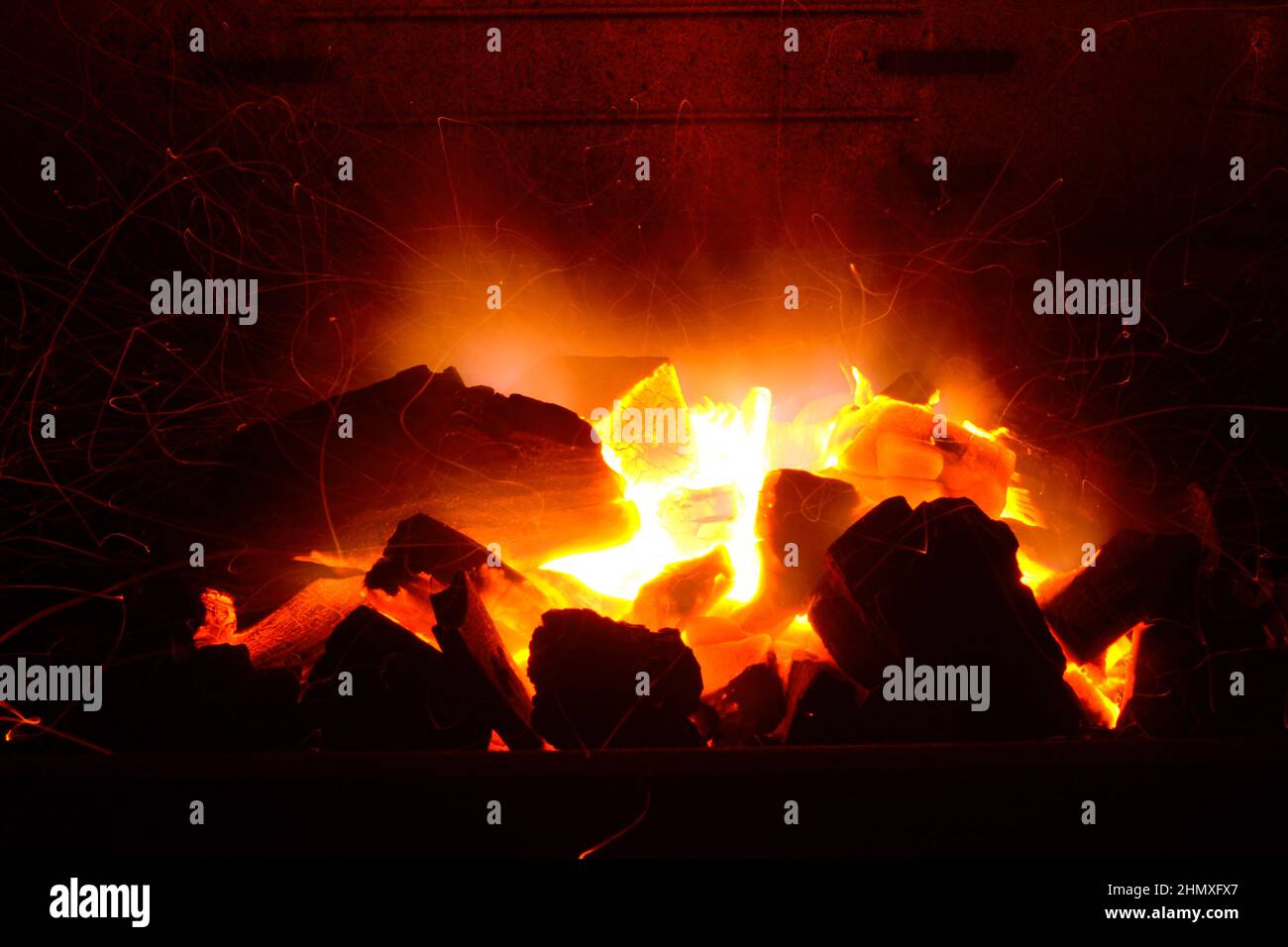 Embers of coal burning.Orange flames blaze in the fire. Bright orange ...
