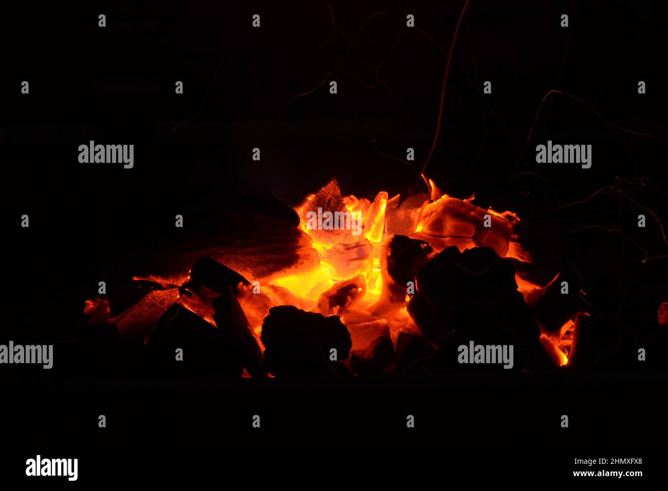 Embers of coal burning.Orange flames blaze in the fire. Bright orange ...