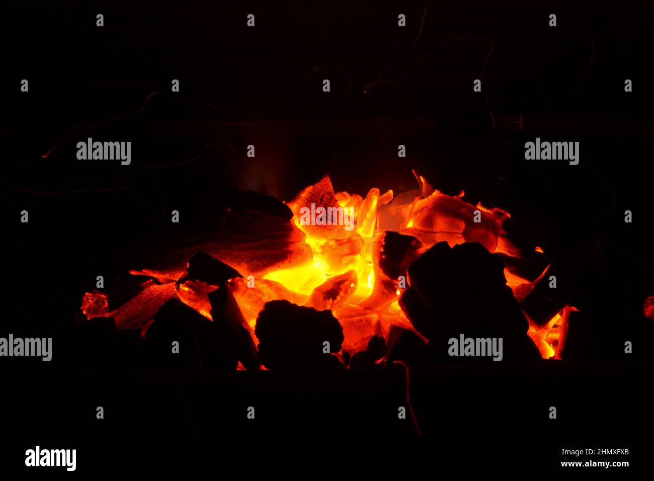 Embers of coal burning.Orange flames blaze in the fire. Bright orange ...