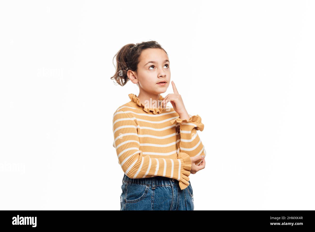 Thoughtful girl thinking about something while standing over an ...