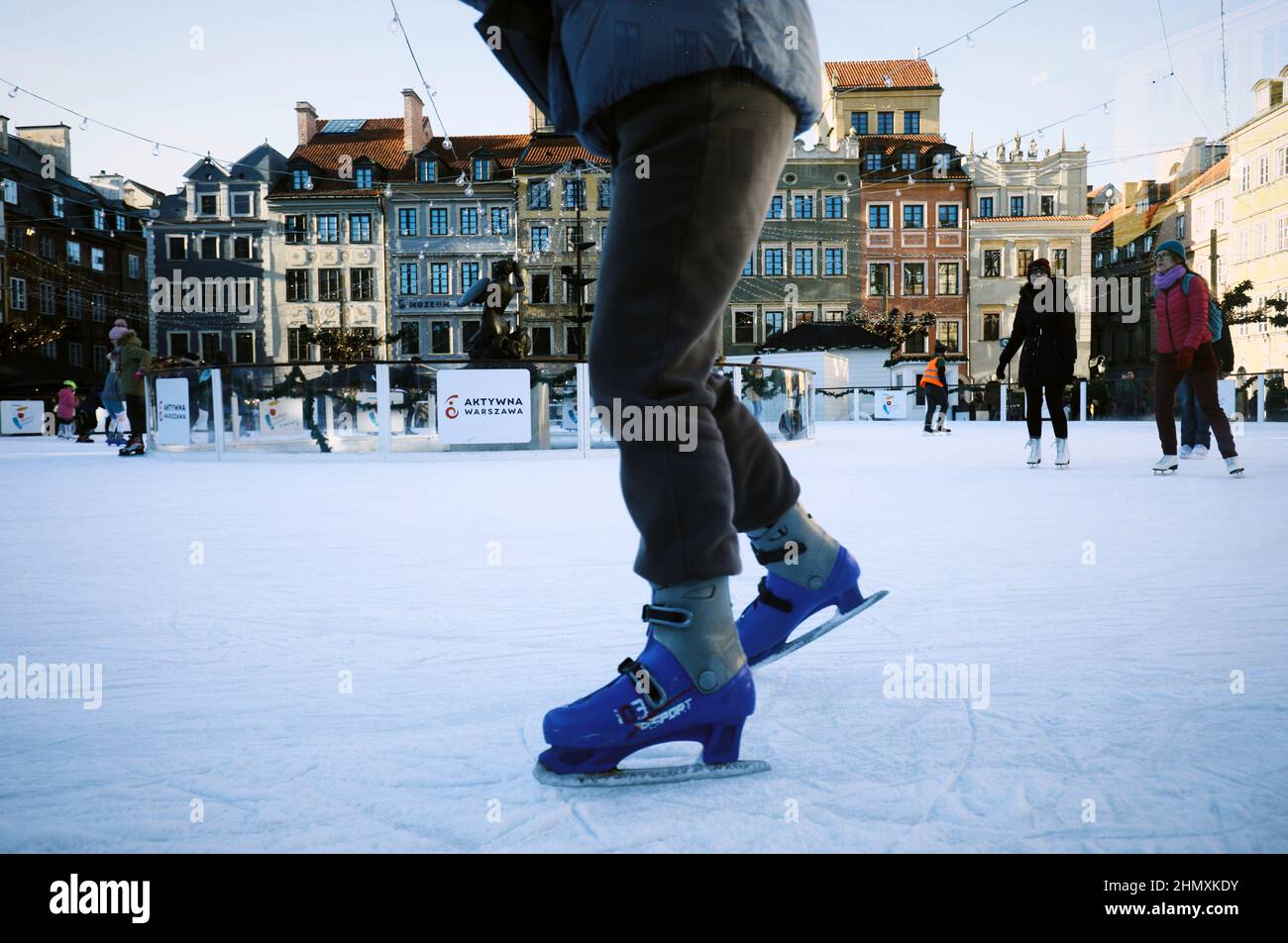 People are seen at an ice skating rink in the Old Town in Warsaw ...