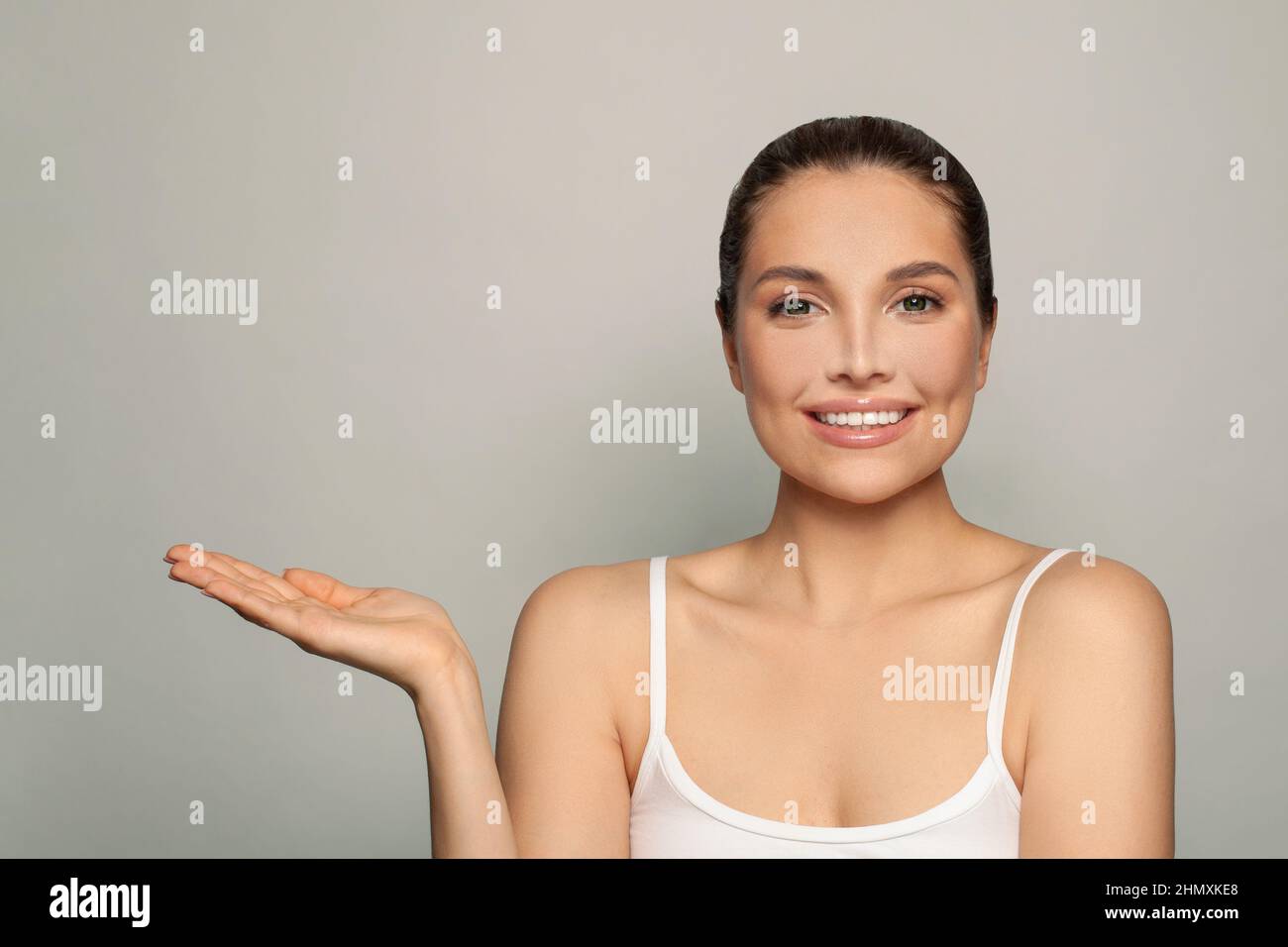 Beautiful woman presenting empty open hand on white background Stock ...