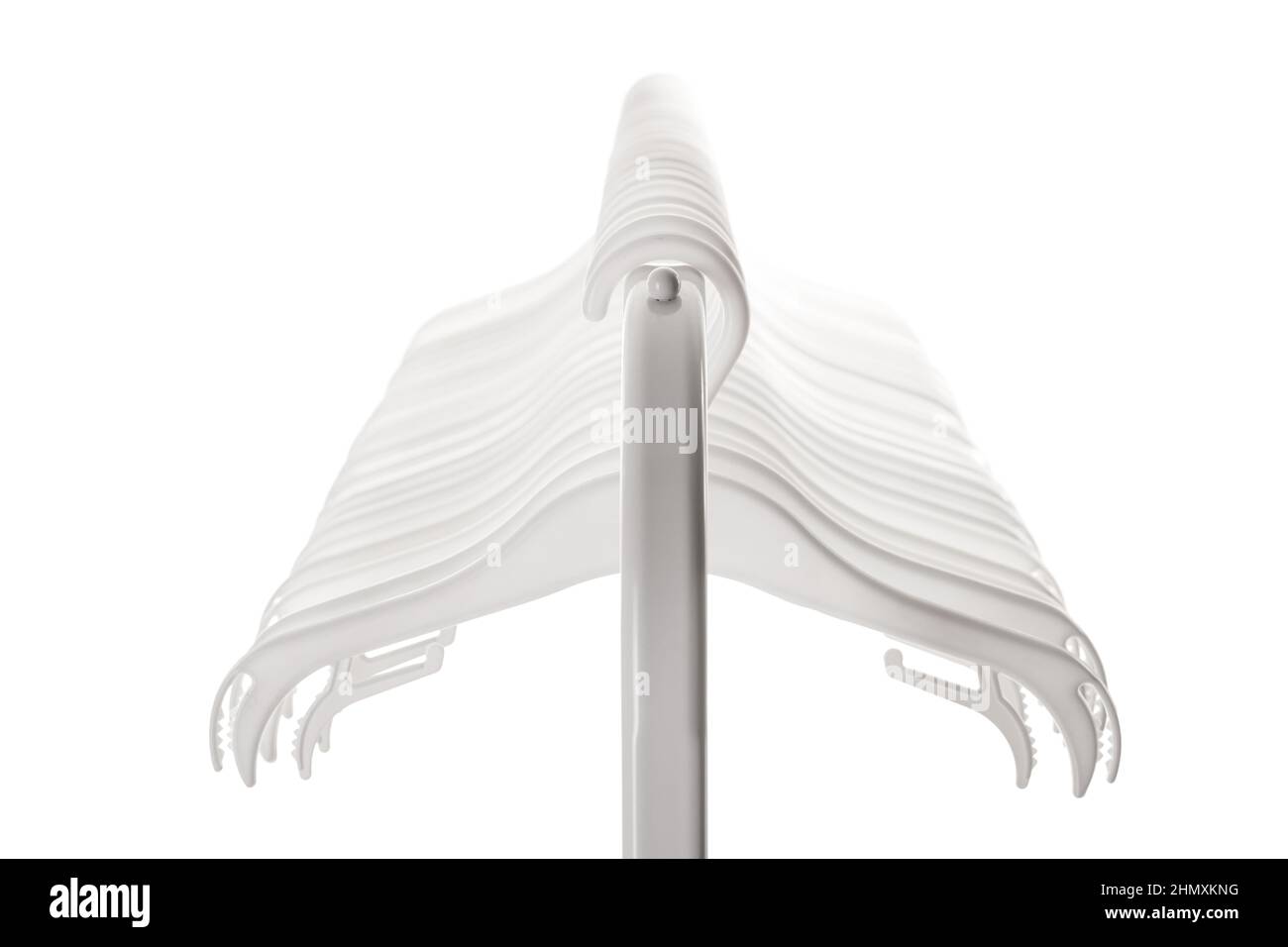 White plastic hangers for clothes hanging on rod from clothing rack ...