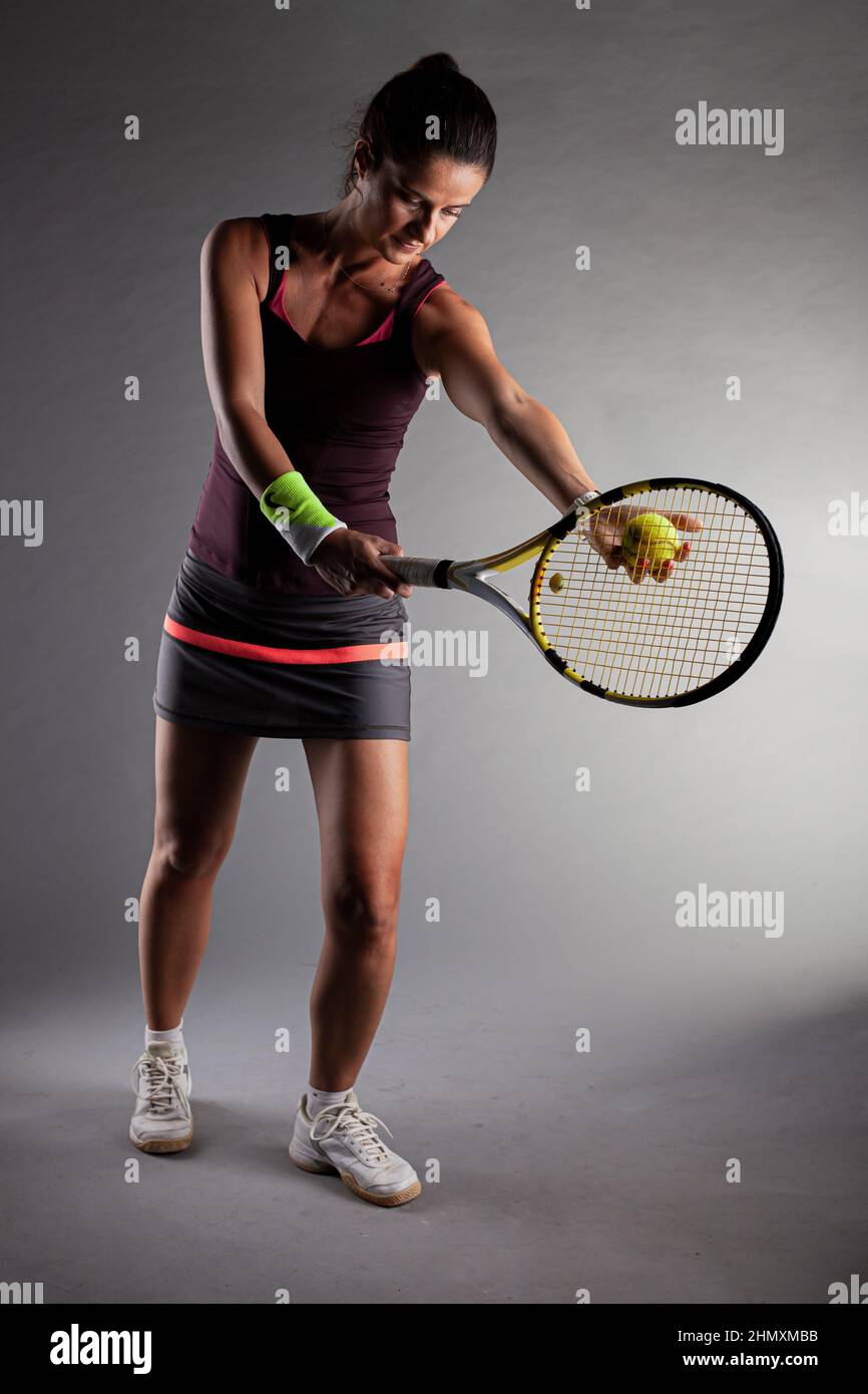 Professional female tennis player. Girl swinging racket preparing to ...