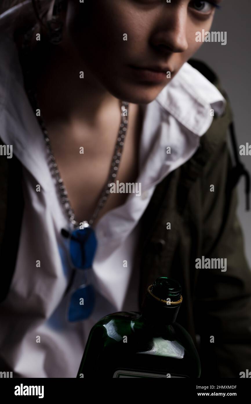 studio portrait of a beautiful girl holding alcohol bottle Stock Photo ...