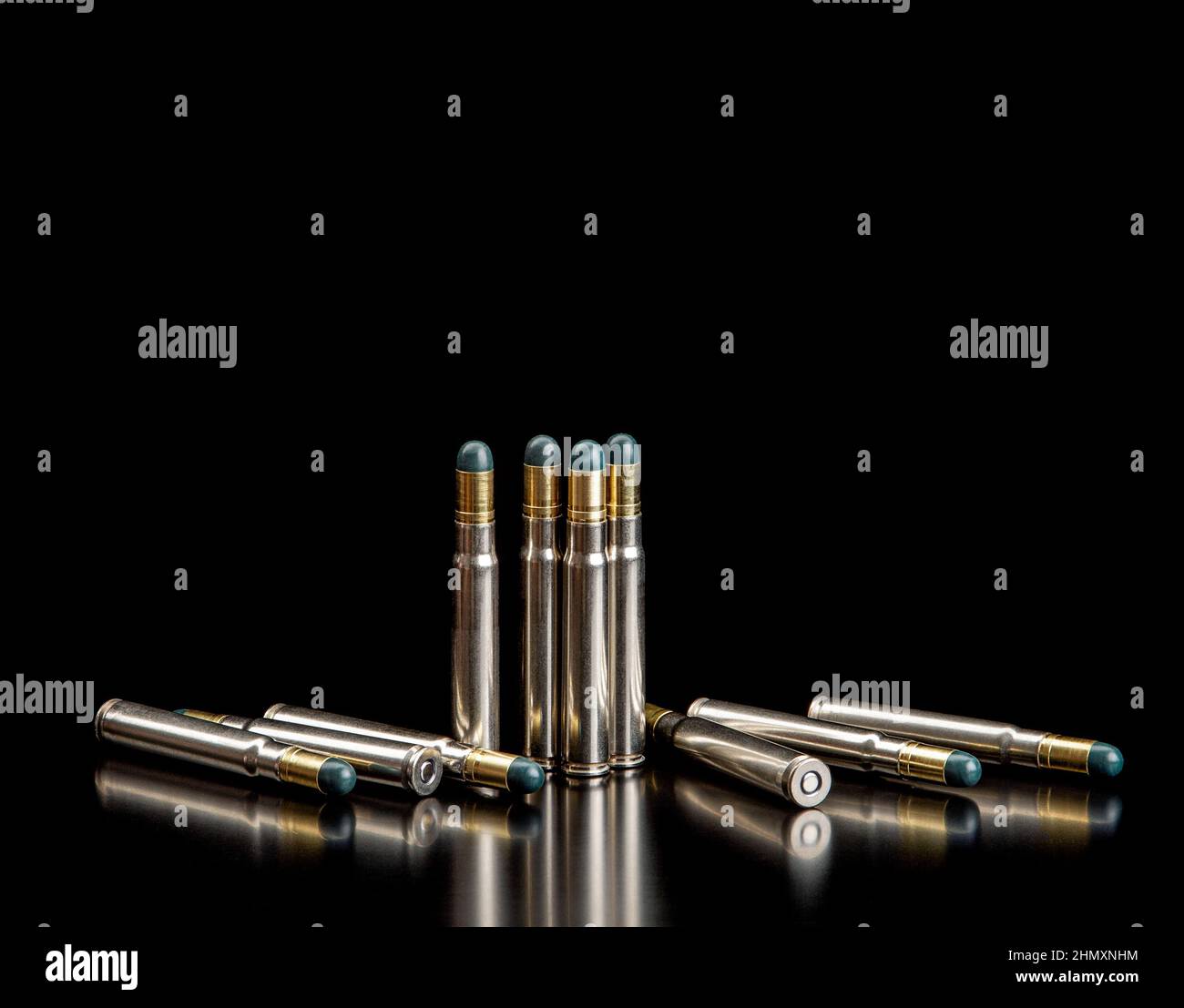 Bullet isolated on black background with reflexion. Rifle bullets close ...