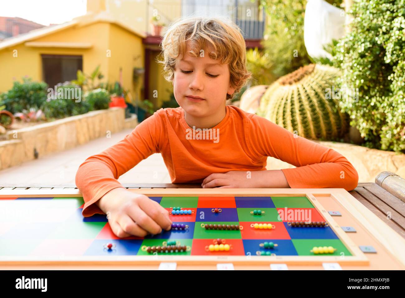 A young elementary school student follows the montessori methodology to ...