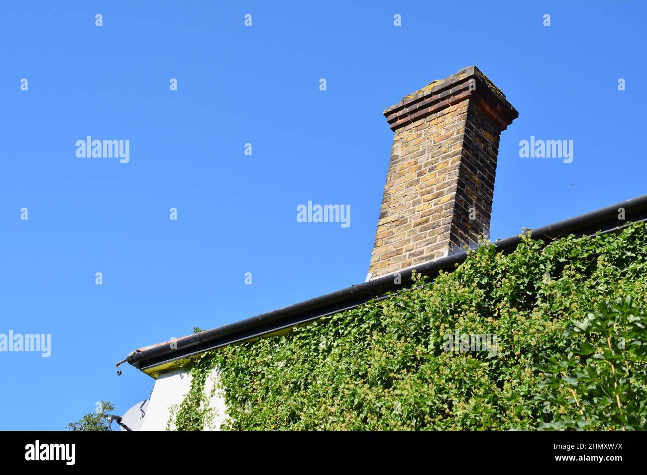 Brick chimney on London house roof in UK Stock Photo - Alamy