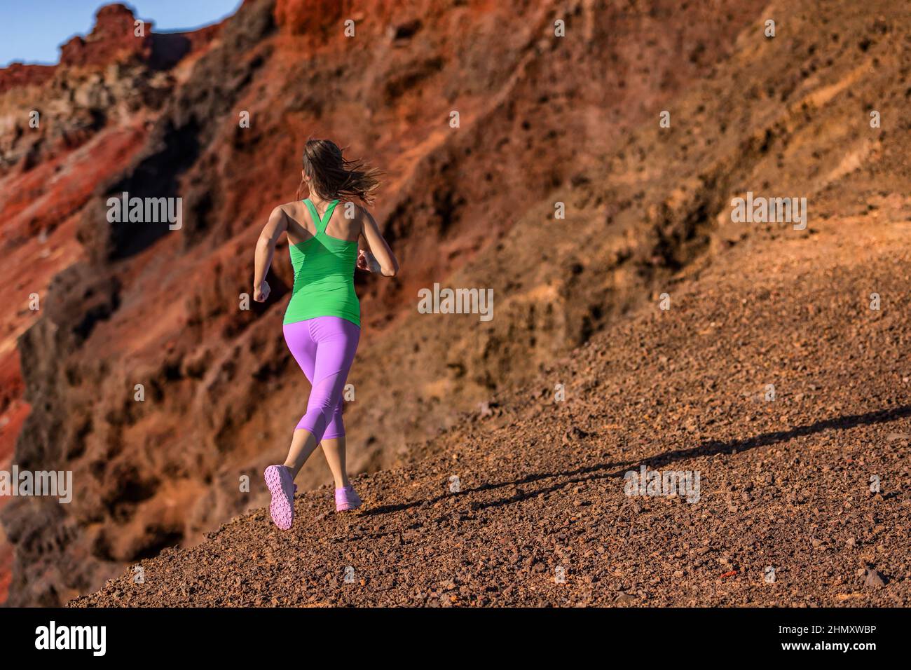 Trail runner woman ultra running uphill on volcano mountainside. Female ...