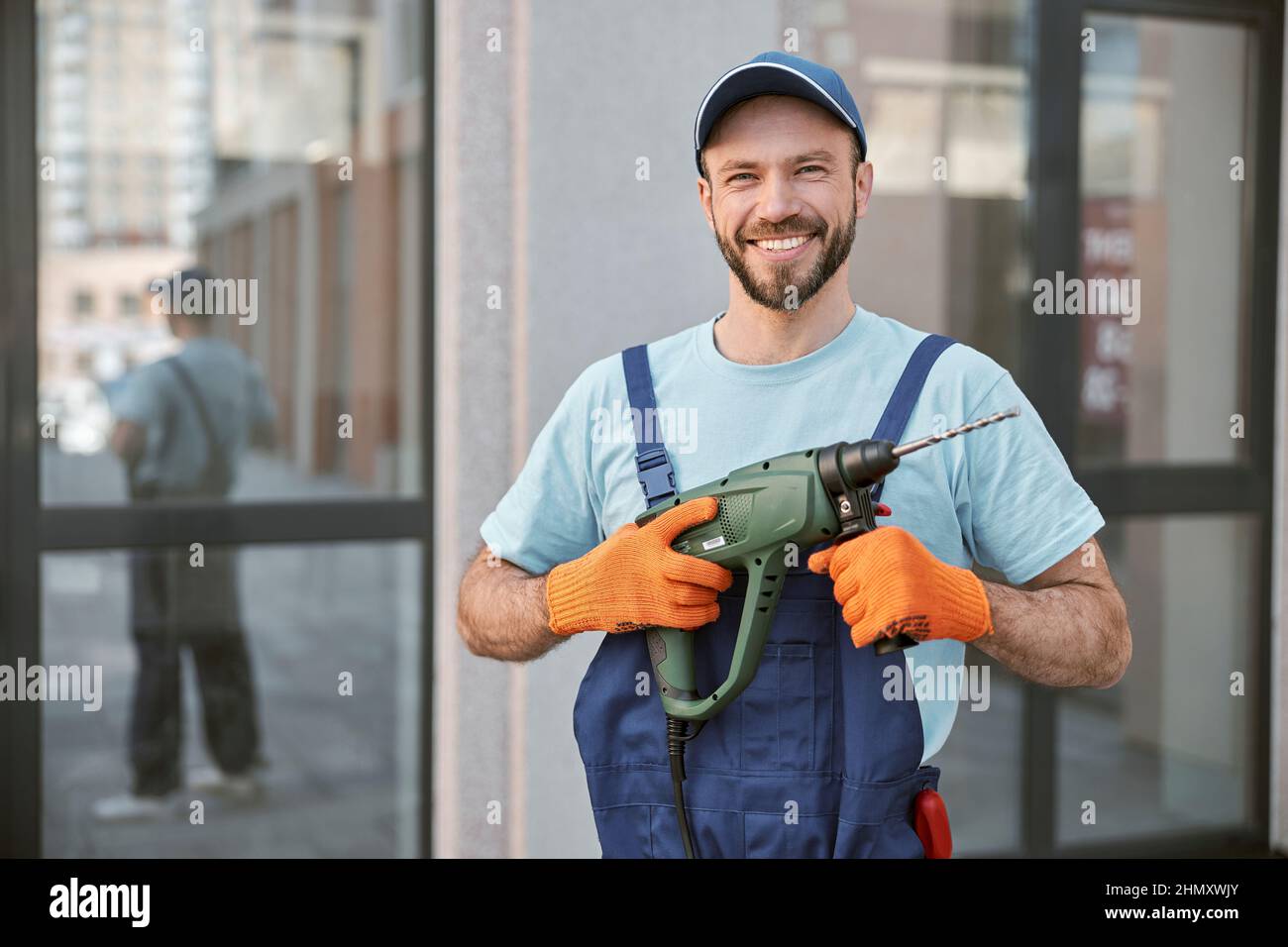 Male construction worker drill smiling hi-res stock photography and ...