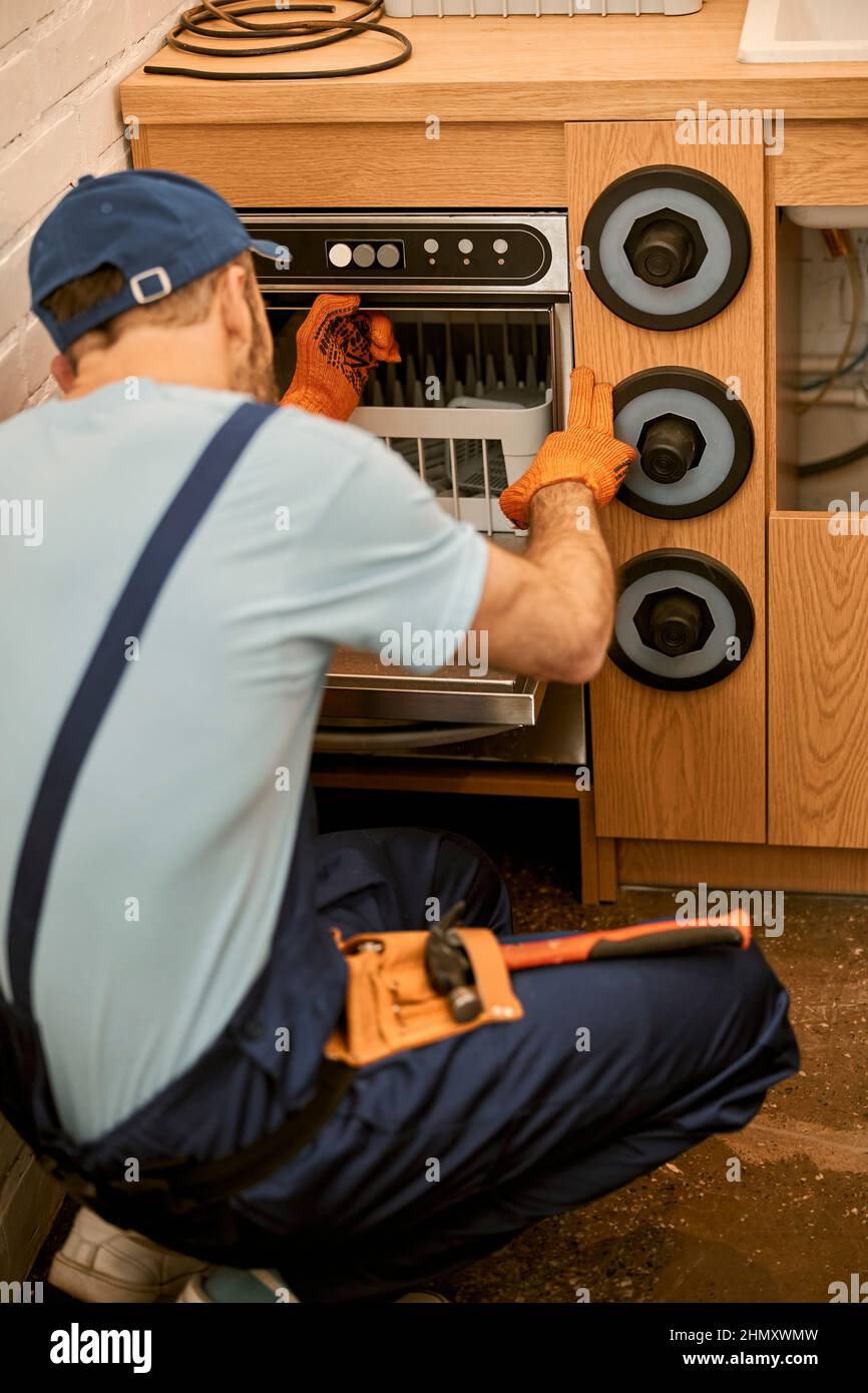 Male worker fixing professional equipment in cafe Stock Photo - Alamy