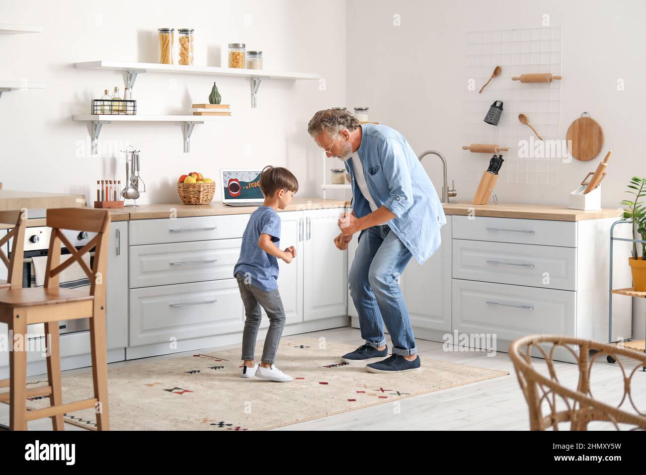 Little boy with his grandfather dancing in kitchen Stock Photo - Alamy