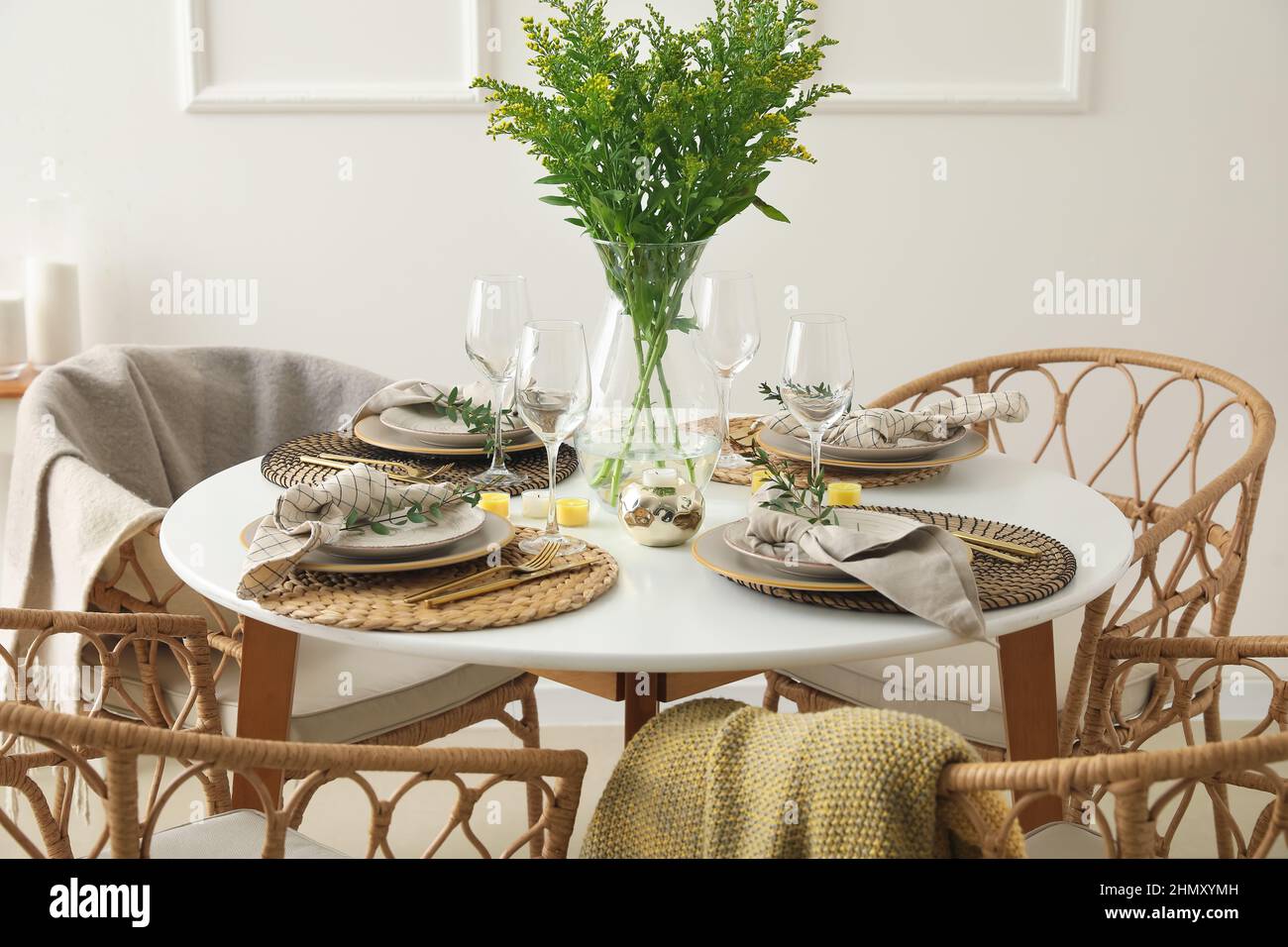 Stylish table setting near white wall Stock Photo - Alamy