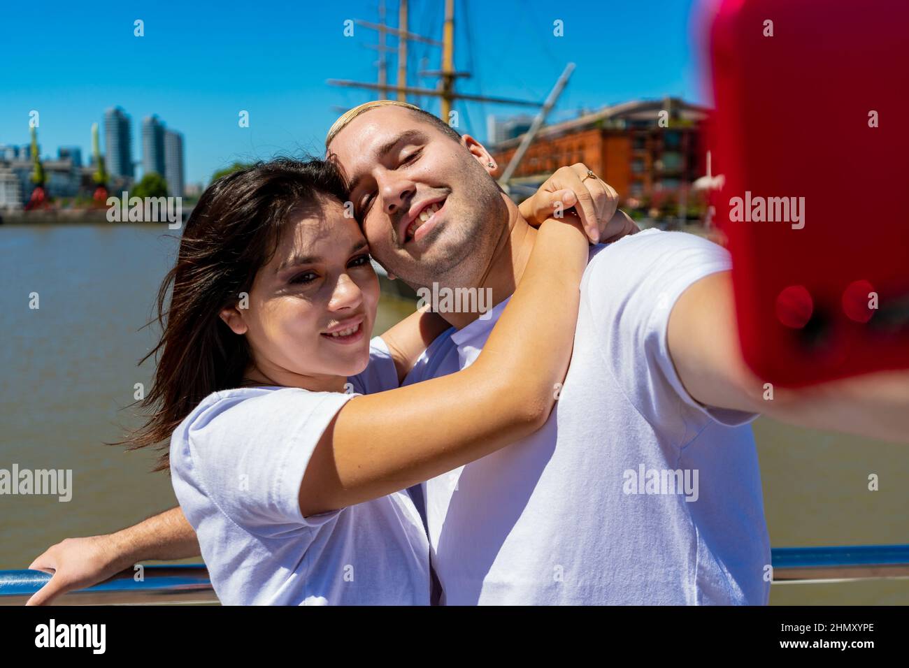 A beautiful young Latin couple taking a selfie. Concept of love, couple ...