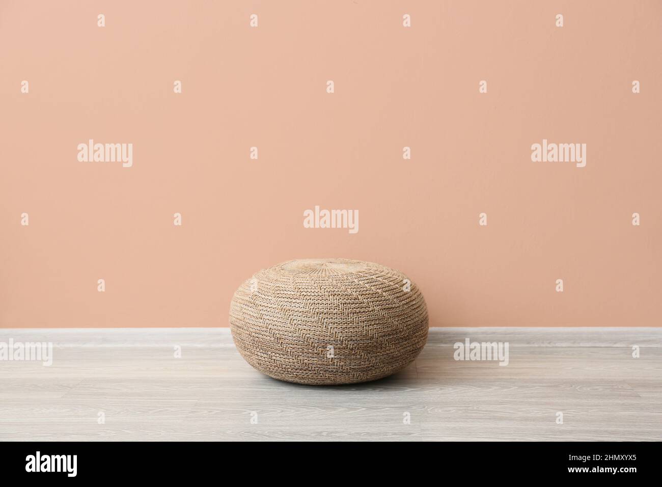 Knitted pouf near beige wall Stock Photo - Alamy