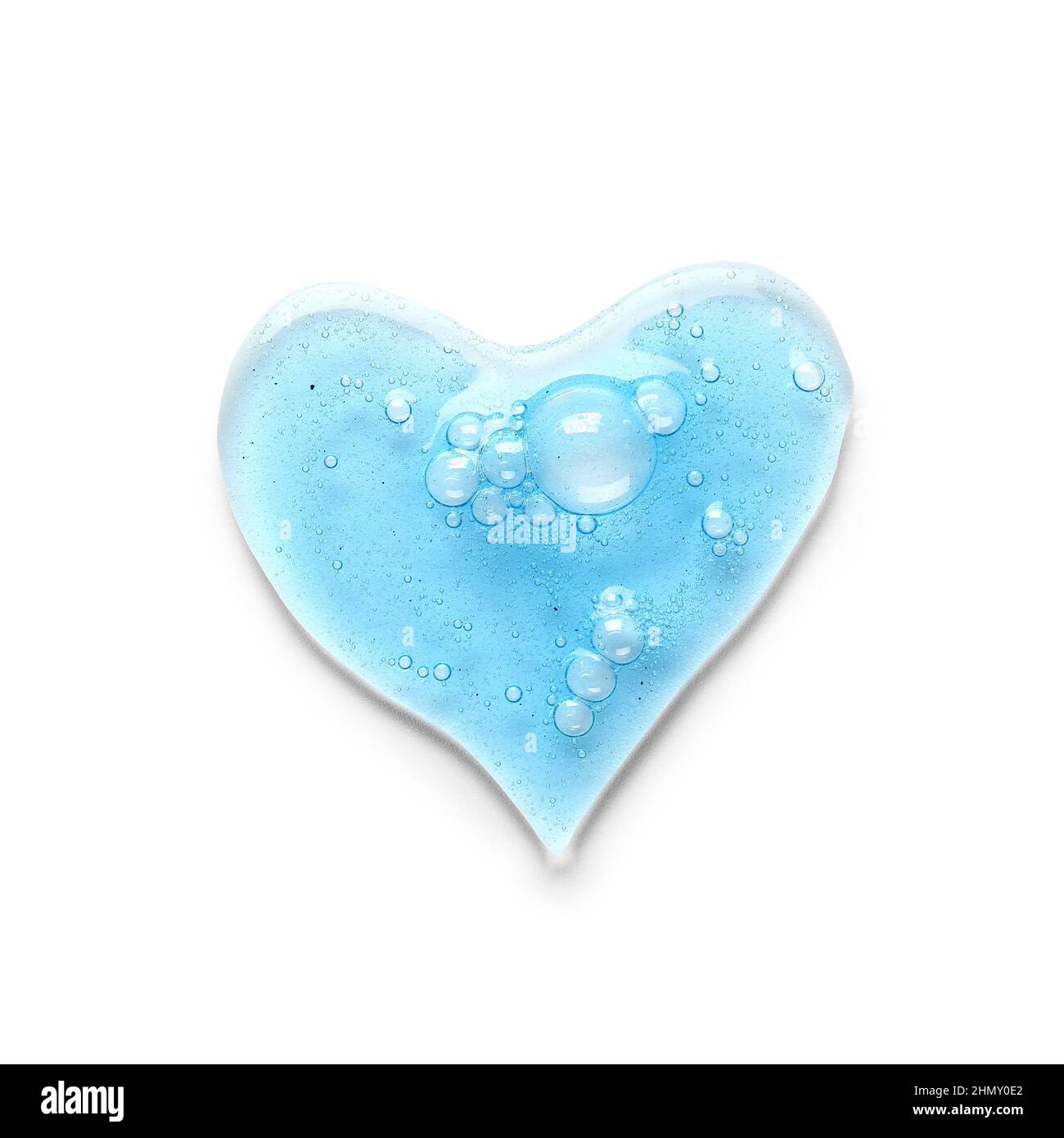 Heart-shaped drop of cosmetic serum on white background Stock Photo - Alamy