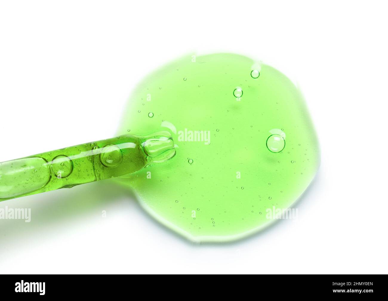 Glass dropper and sample of cosmetic serum on white background Stock ...