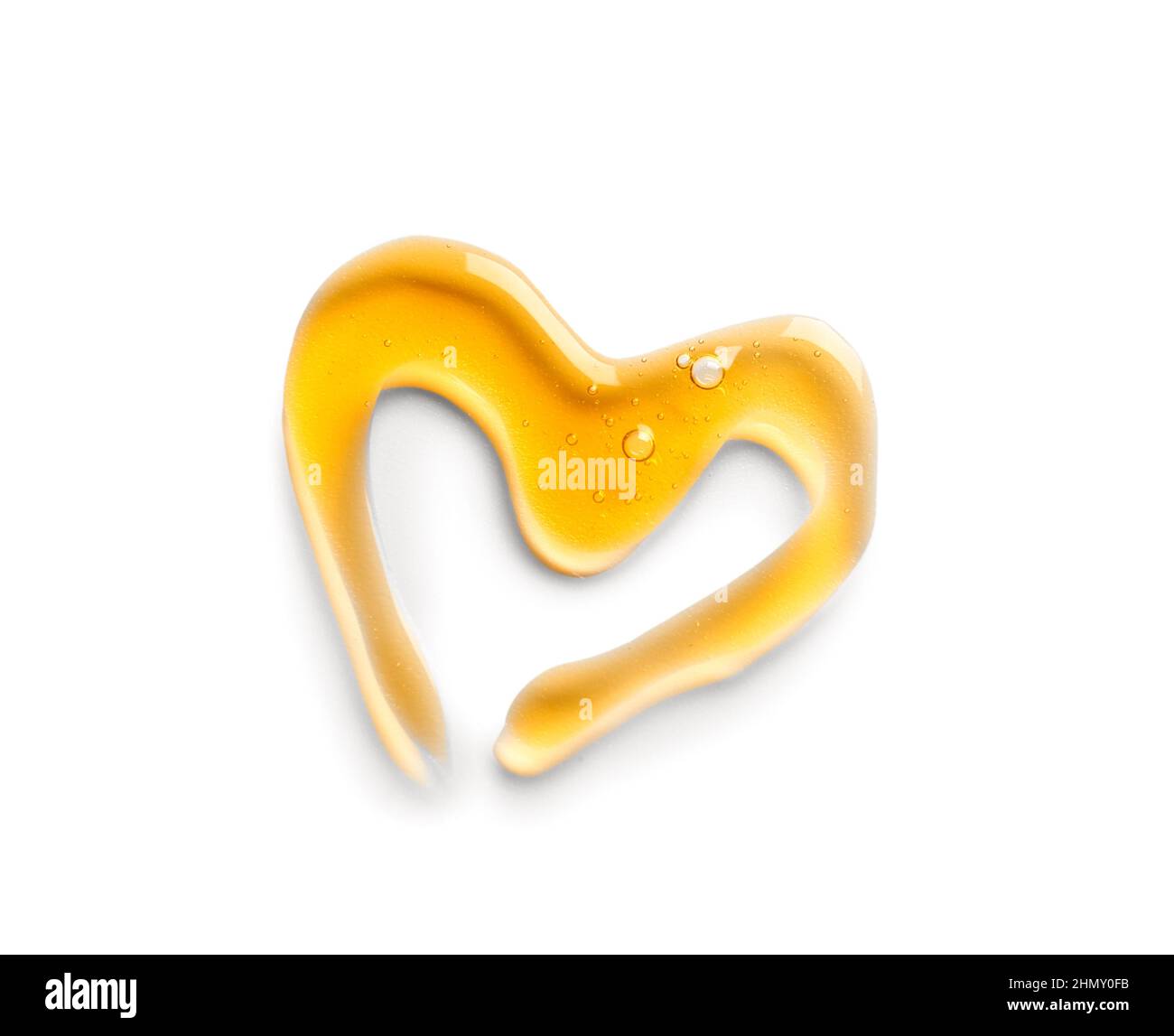 Heart-shaped drop of cosmetic serum on white background Stock Photo - Alamy