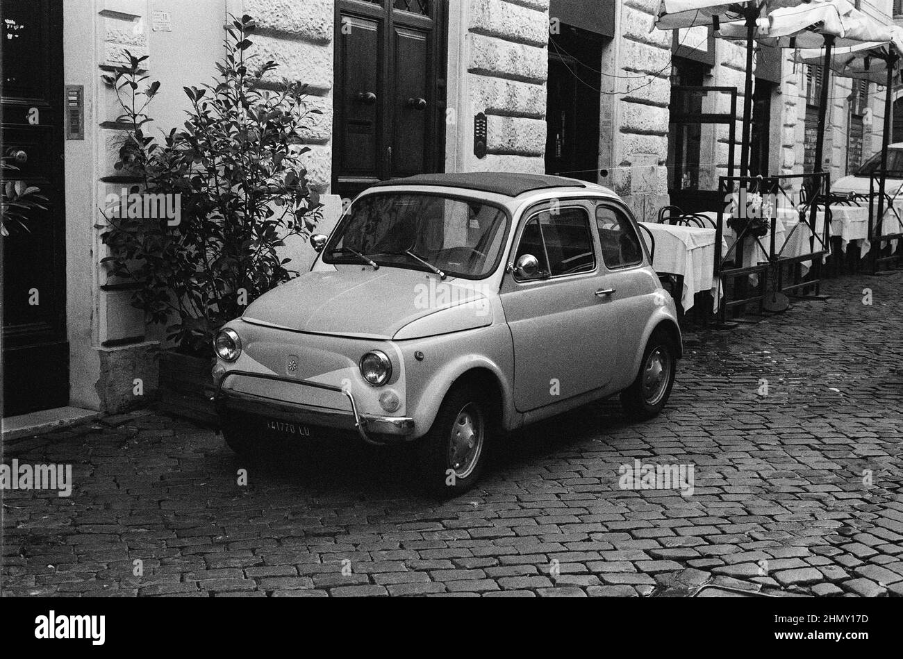 Black and white photo of a classic Italian car, typical Fiat 500 in the ...