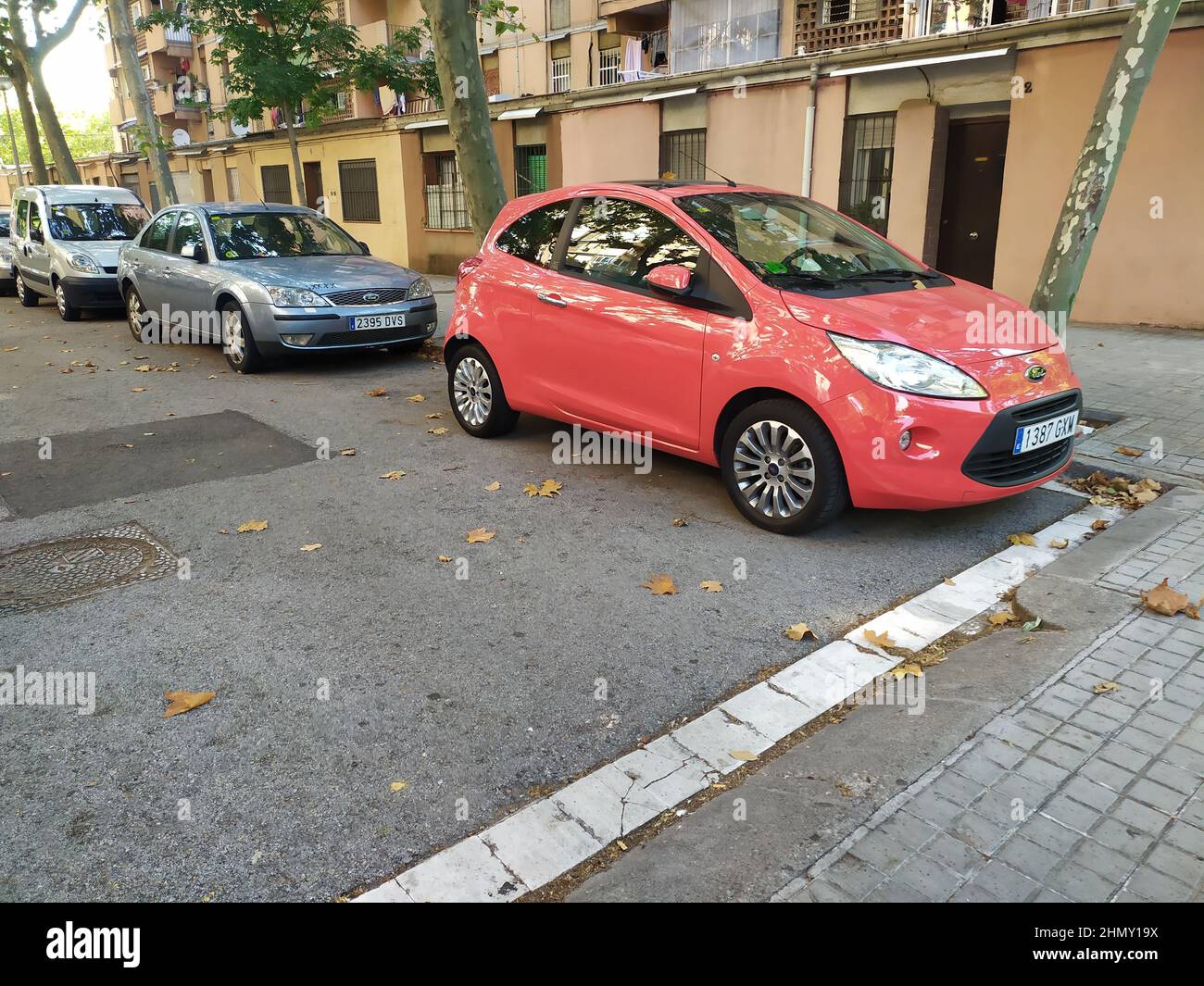 Photo of a red little car parked in the street Stock Photo - Alamy