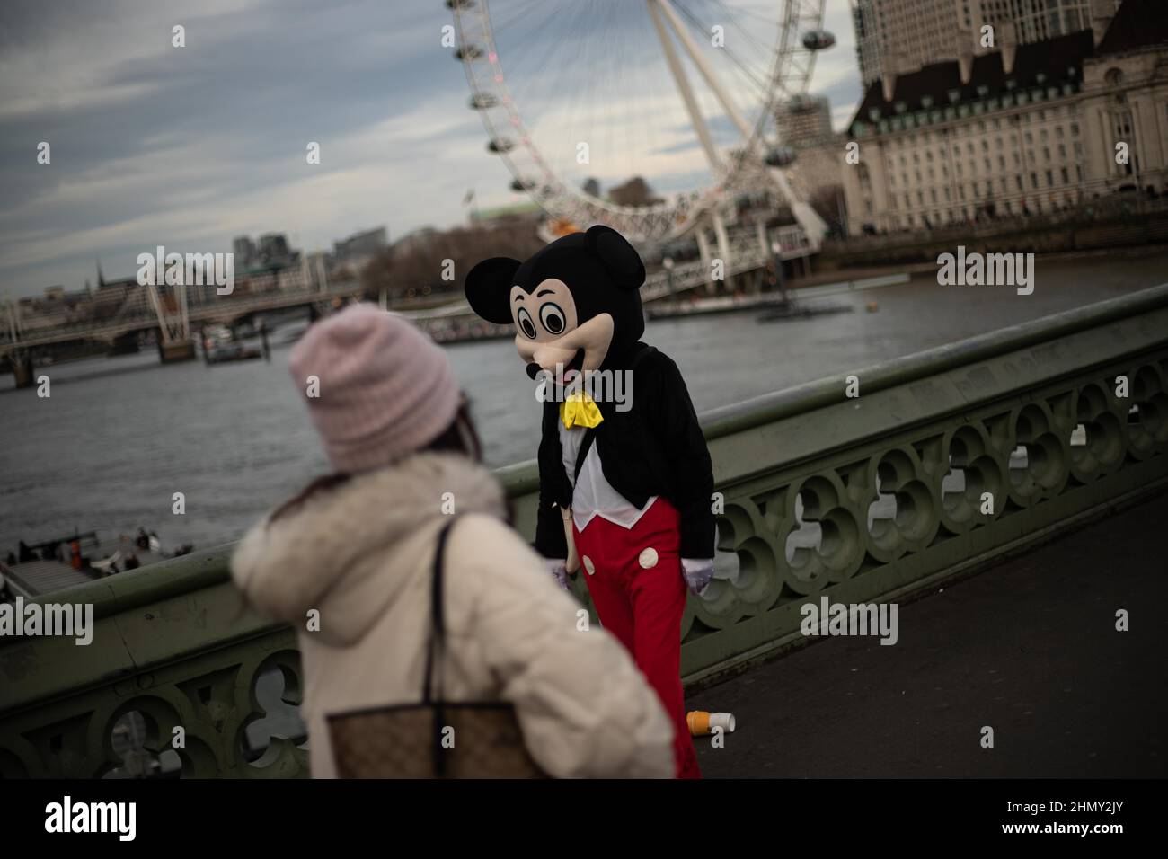London, UK. 12th Feb, 2022. An entertainer dressed as Micky Mouse walks ...