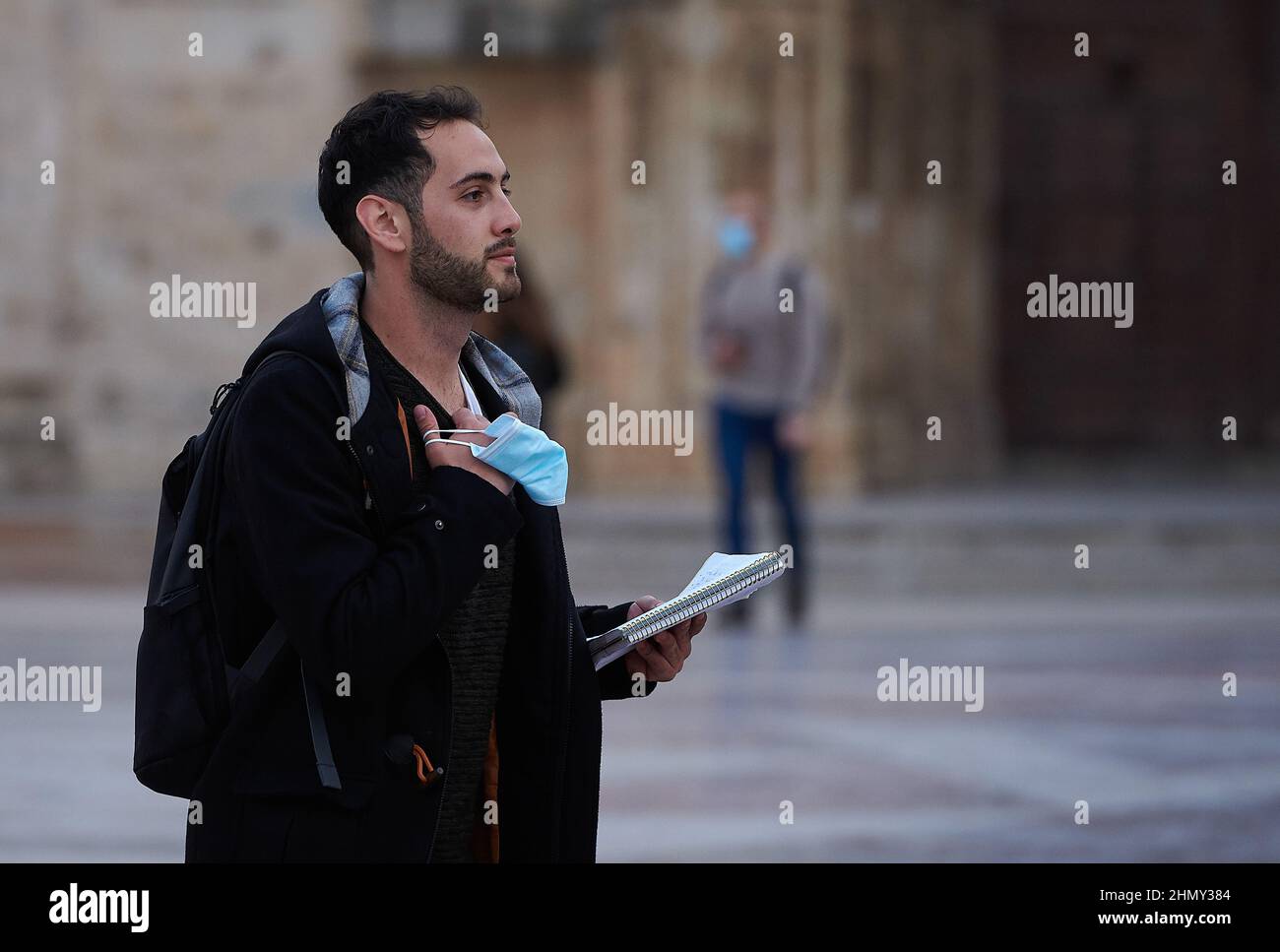 Valencia, Spain. 11th Feb, 2022. A man with a mask on his hand walks in ...