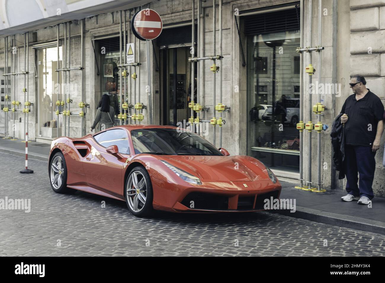 Photo of a red Ferrari 488 GTB parked in the street, center of city ...