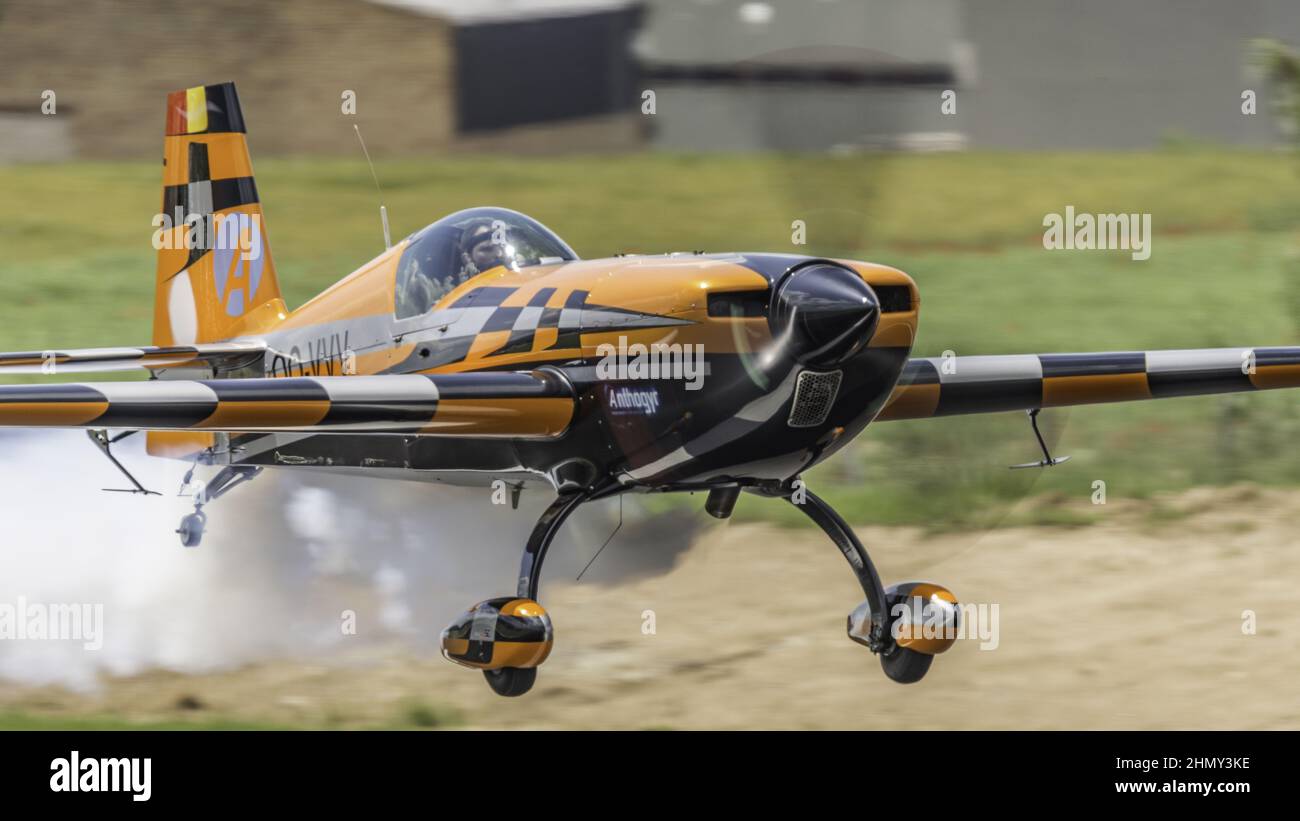 Photo of an acrobatic airplane show with white smoke, Extra 330sc Stock ...