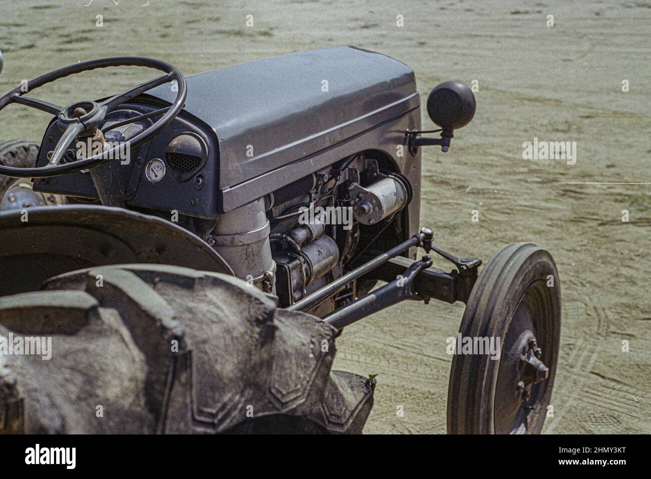 Photo of a red and old Ferguson tractor in the park, and a closeup ...