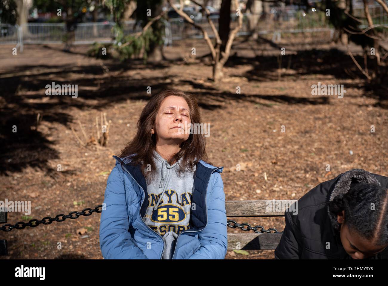 New York, NY, USA - February 11, 2022: Woman sleeping in the sunlight ...