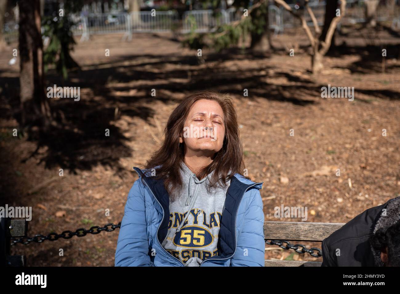 New York, NY, USA - February 11, 2022: Woman sleeping in the sunlight ...
