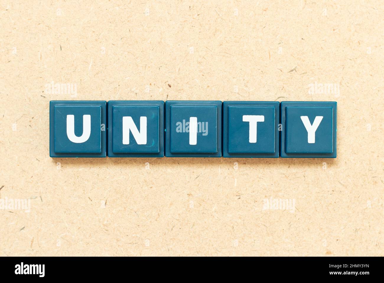 Tile alphabet letter in word unity on wood background Stock Photo - Alamy