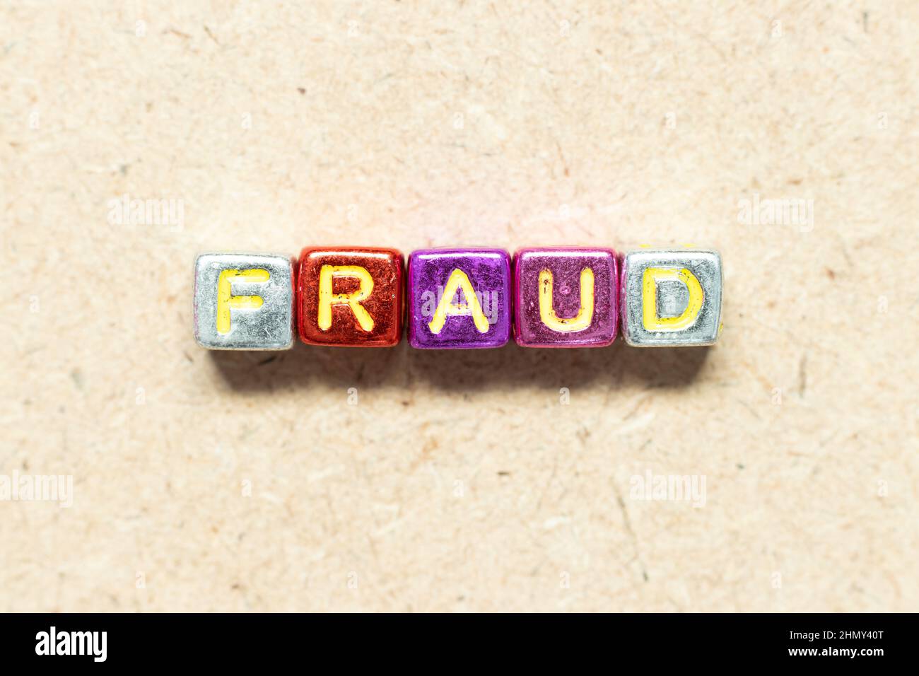 Metallic color alphabet letter block in word fraud on wood background ...