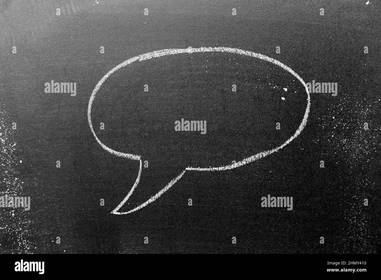White color chalk hand drawing in round bubble speech shape with blank ...