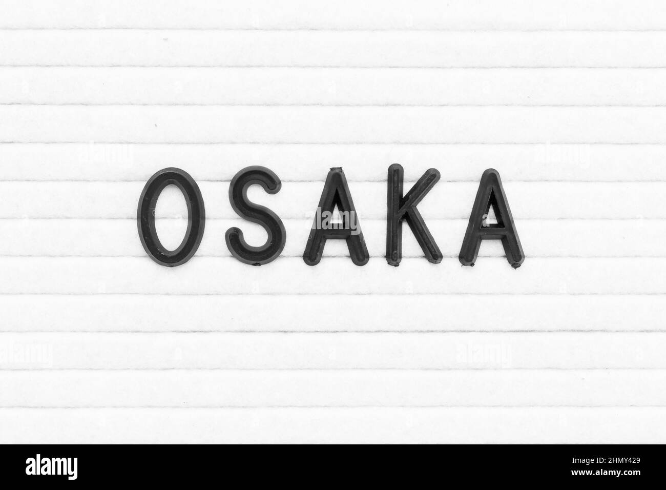 Black color letter in word osaka on white felt board background Stock ...