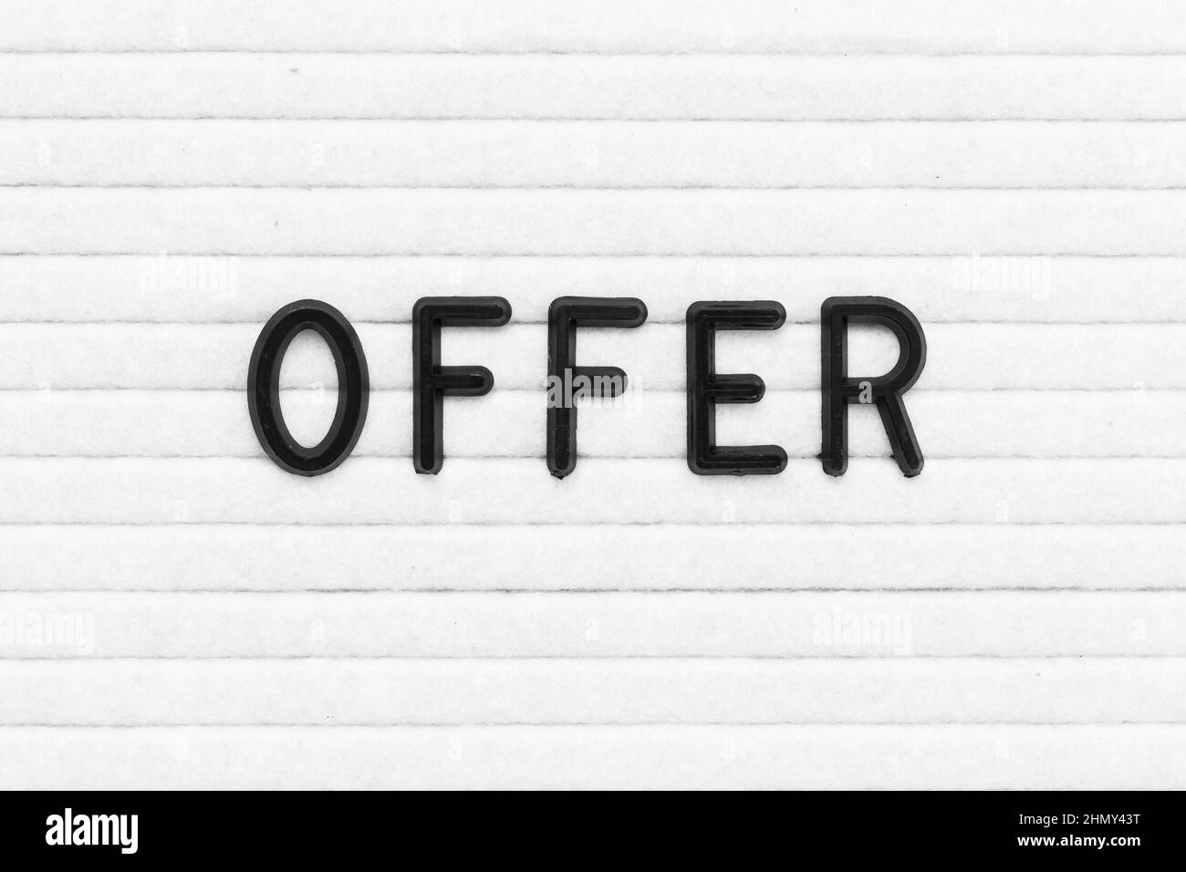 Black color letter in word offer on white felt board background Stock ...