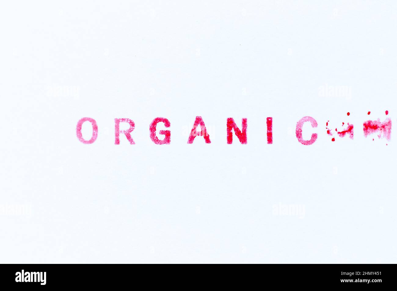 Red color ink rubber stamp in word organic on white paper background ...