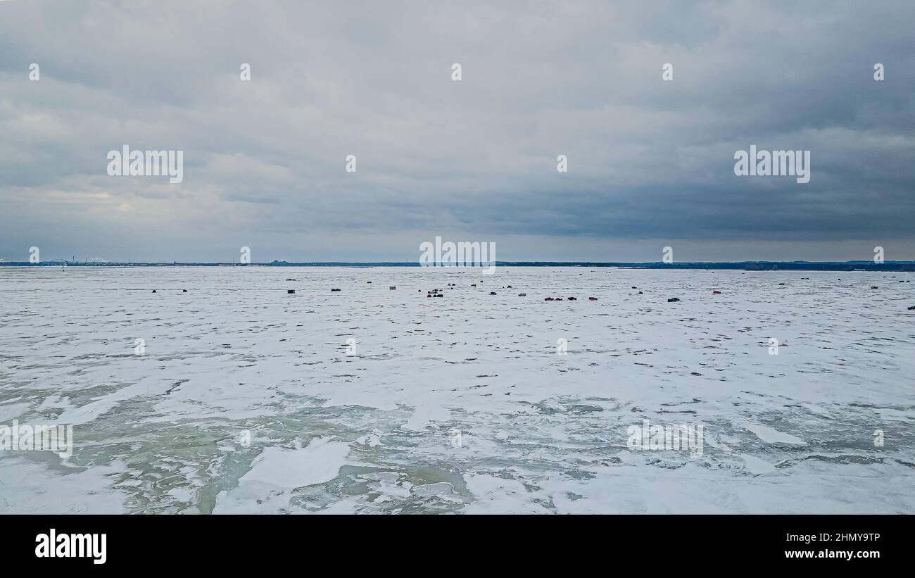 A cold view of the ice fishing huts over the frozen bay Stock Photo - Alamy