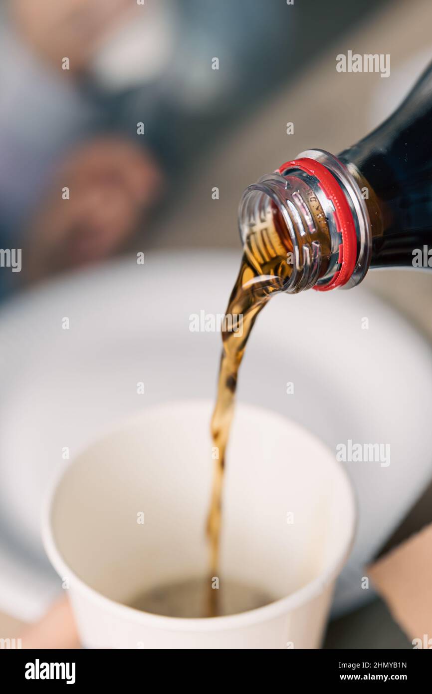 Pouring soda drink from bottle to glass, close up Stock Photo - Alamy