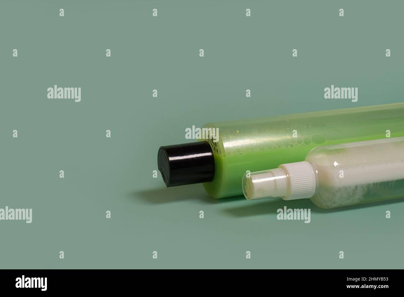 Plastic containers with shampoo and hair firming agent Stock Photo - Alamy