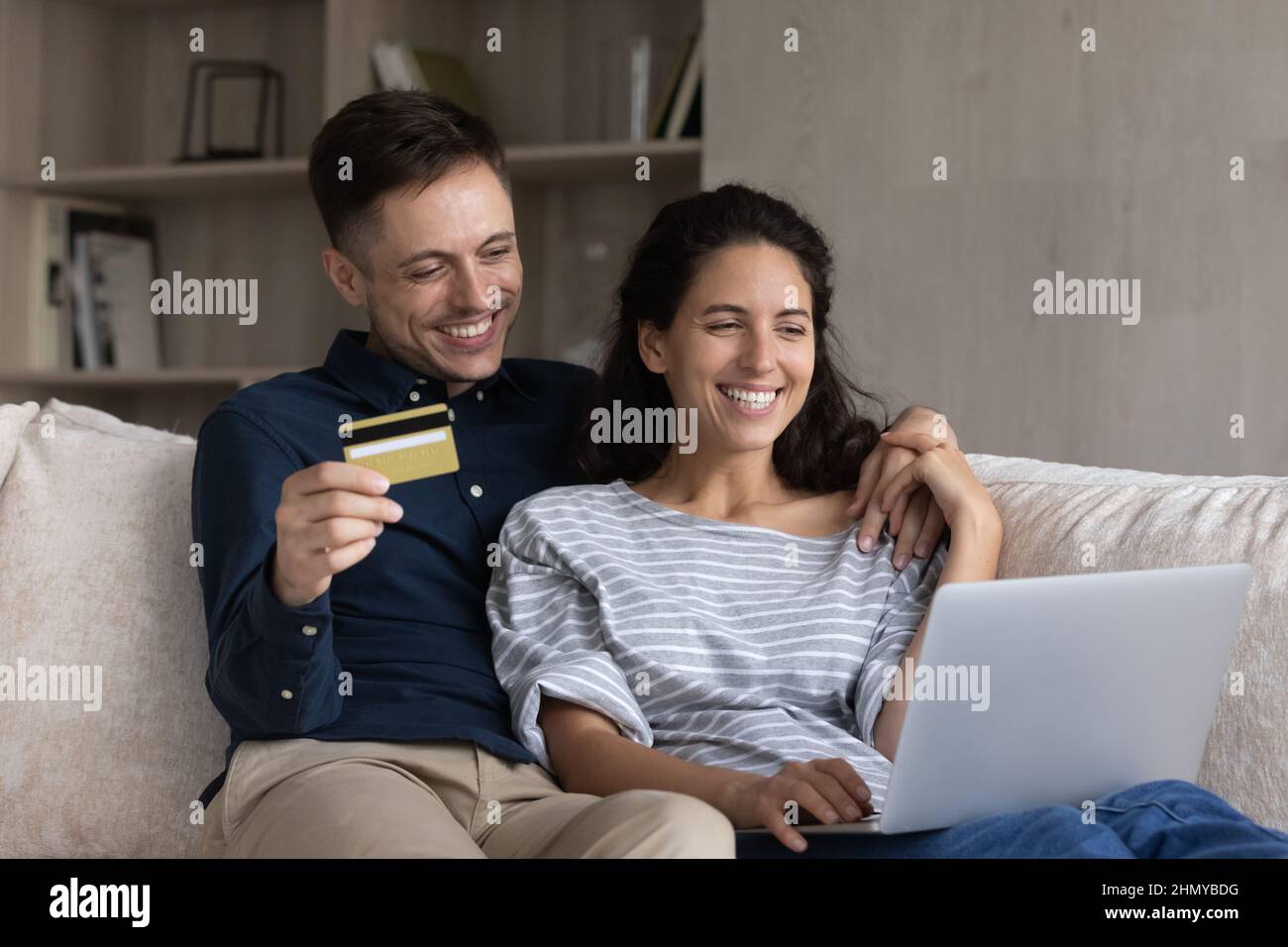 Happy millennial married couple shopping on internet together Stock ...