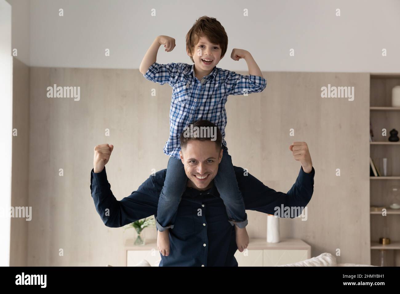 Cheerful little boy riding on happy dads neck and shoulders Stock Photo ...
