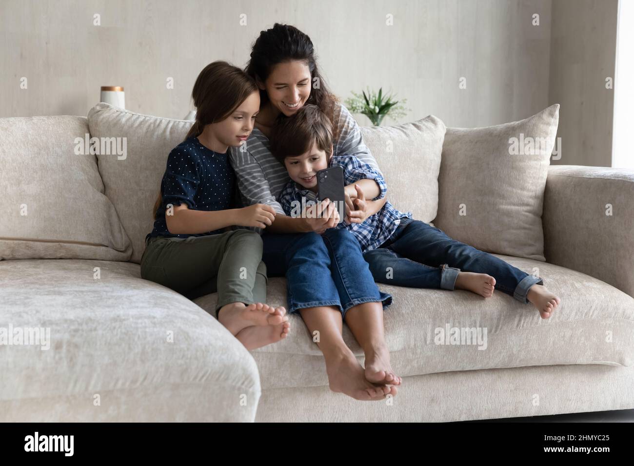 Happy mom and cheerful gen Z kids using digital gadget Stock Photo - Alamy
