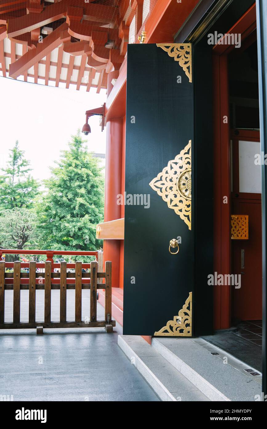 Vertical shot of a black and gold door of a shinto shrine in Kyoto ...